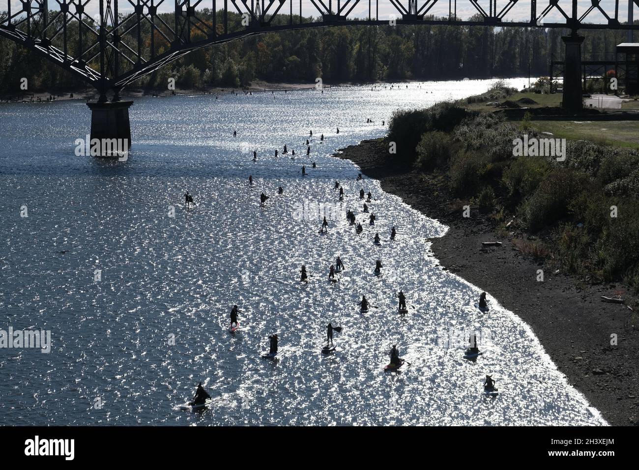 People take part in the Fourth Annual Stand Up Paddleboard Witch Paddle ...
