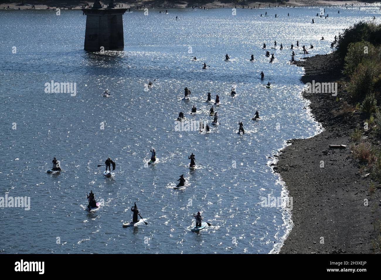 People take part in the Fourth Annual Stand Up Paddleboard Witch Paddle ...