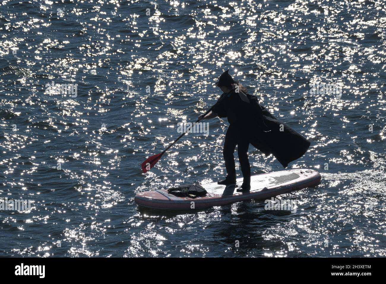 A participant takes part in the Fourth Annual Stand Up Paddleboard ...
