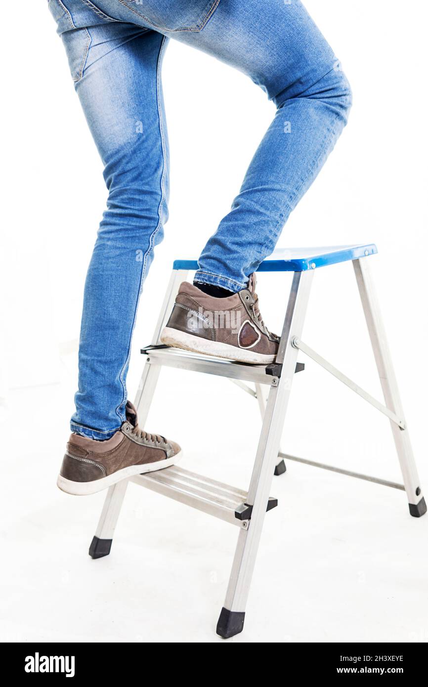 young worker climbing the ladder isolated on white Stock Photo - Alamy