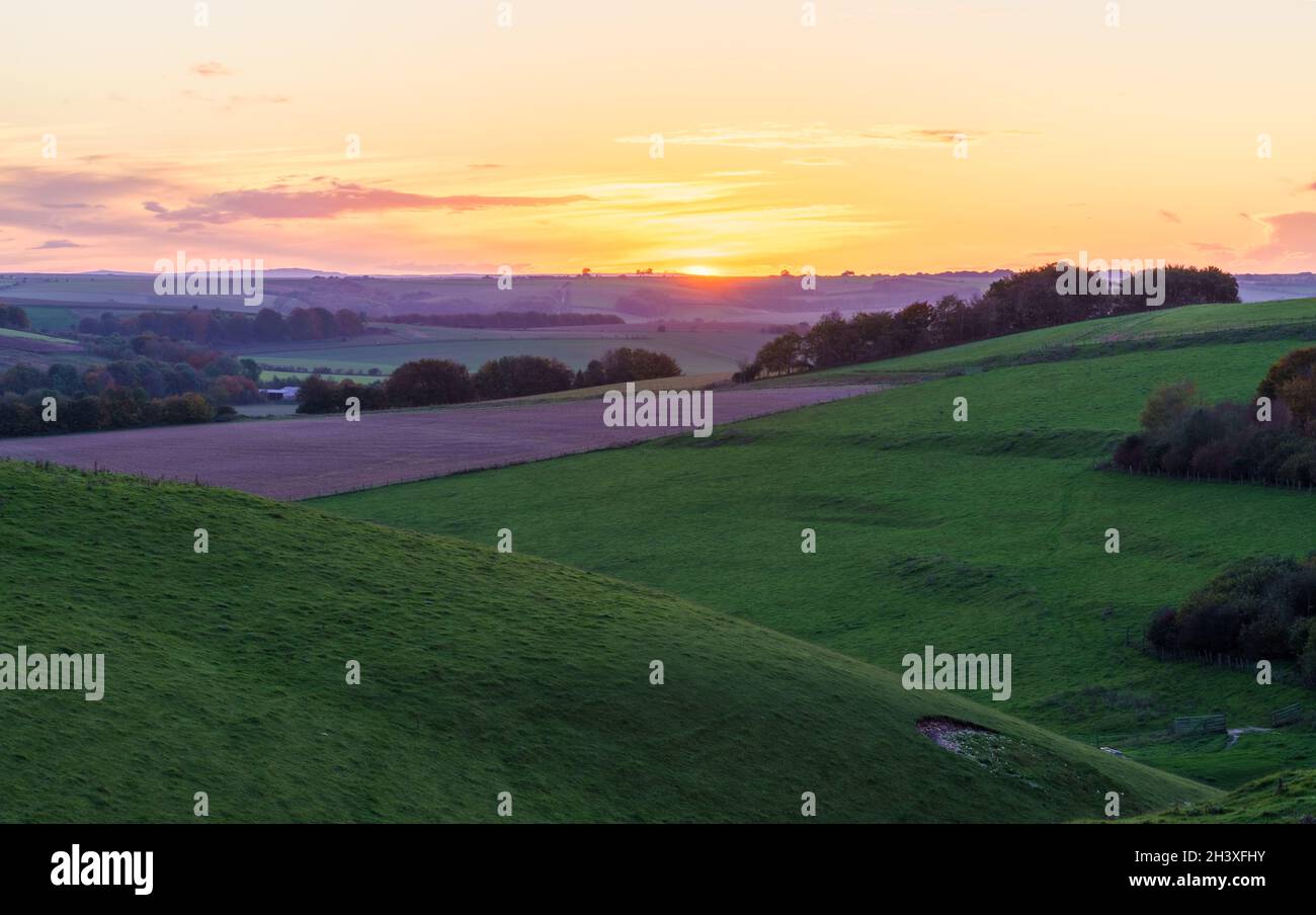 passing glimpse of a golden sunset, minimal cloud on the horizon over a ...
