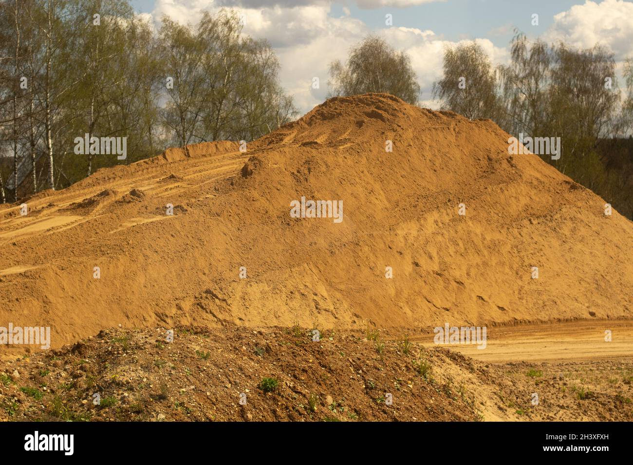 Mountain of sand. Embankment for the construction of the route. Sand on ...
