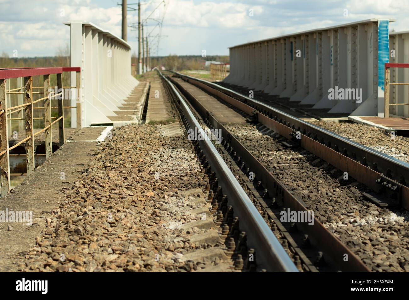 The railway is one lane. The line converges in the distance. The road ...