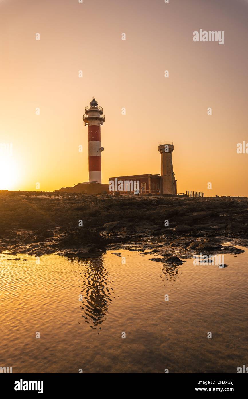 Vertical shot of the Toston Lighthouse at sunset in Punta Ballena ...