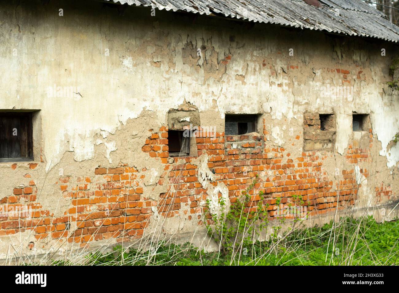 An abandoned house with broken windows. Old building in the city ...