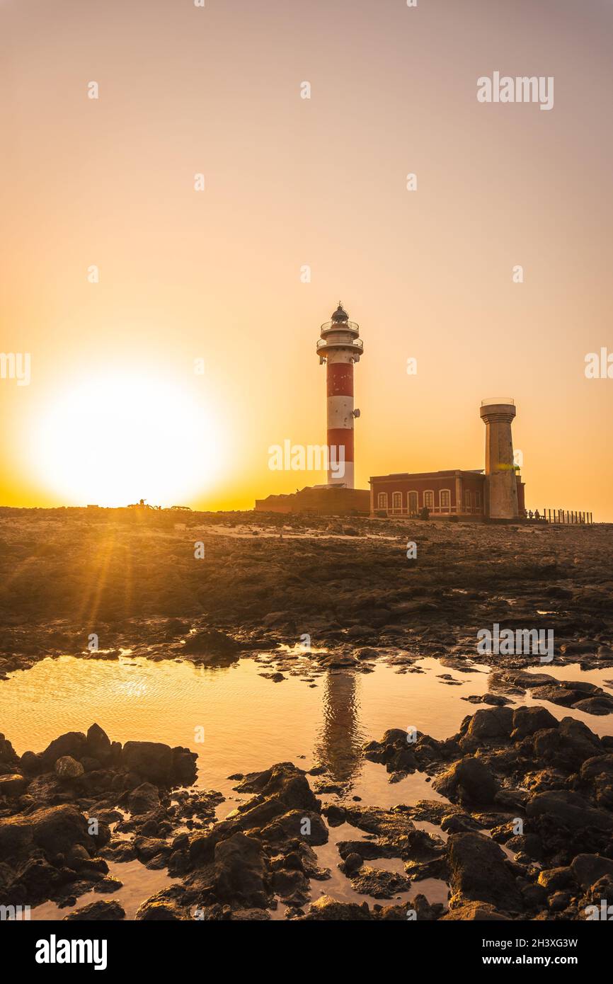 Vertical shot of the Toston Lighthouse at sunset in Punta Ballena ...