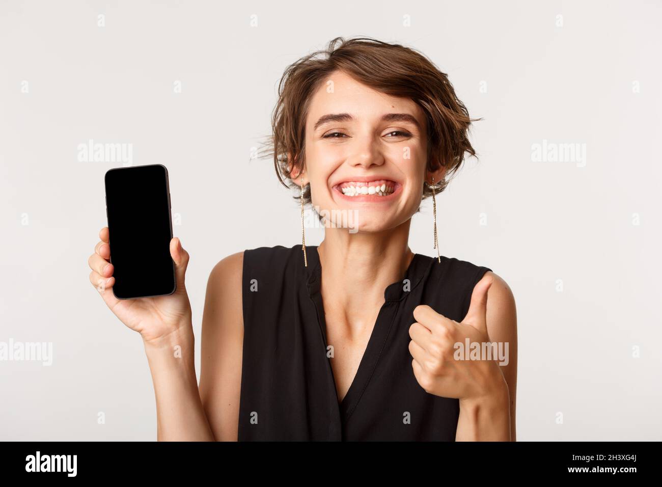 Image of happy satisfied woman recommending something, showing thumbs ...