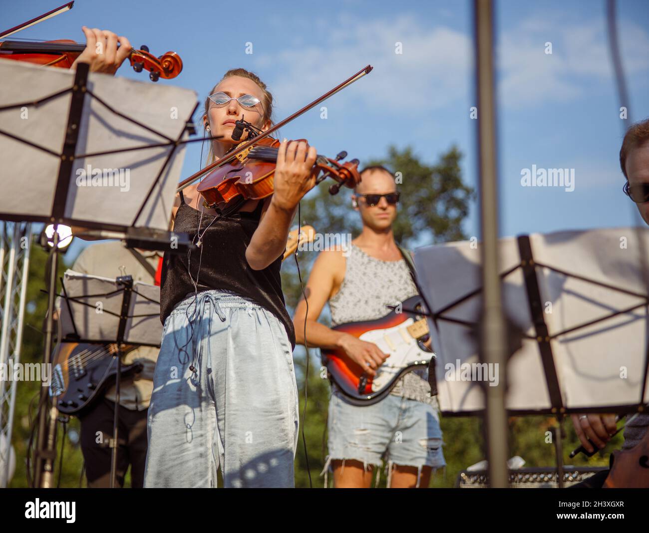Charming woman violinist playing violin in orchestra Stock Photo - Alamy