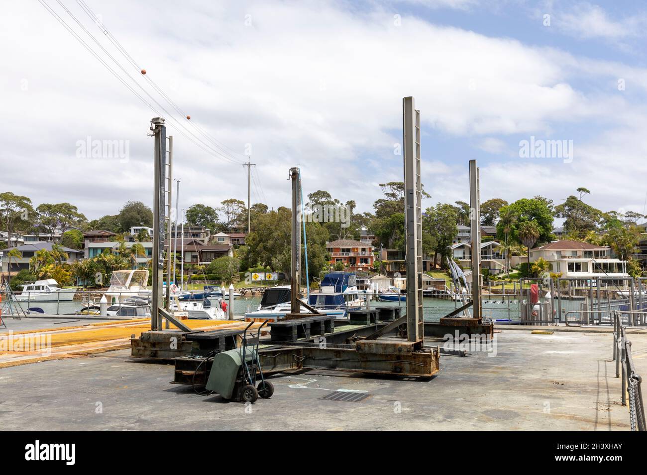 Working boat marina on Pittwater in Sydney with crane hoist and other ...