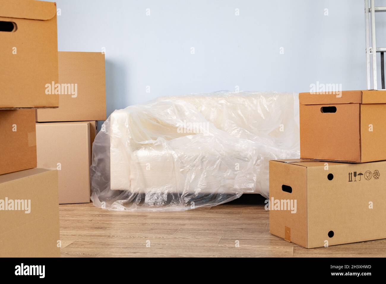 Packed household stuff in boxes and packed sofa for moving Stock Photo ...