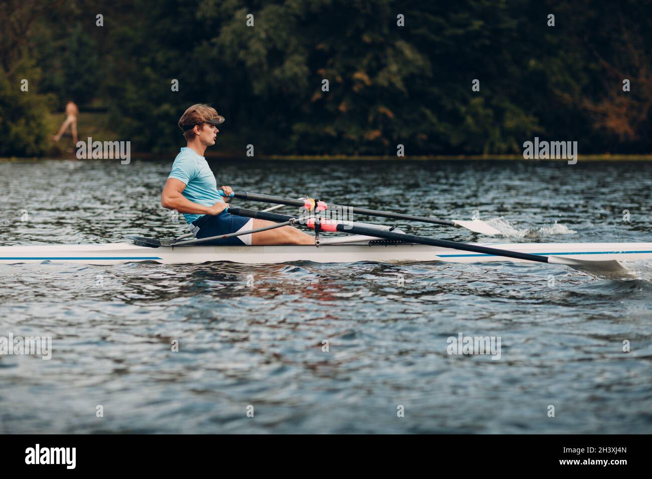 Sportsman single scull man rower rowing on boat Stock Photo - Alamy