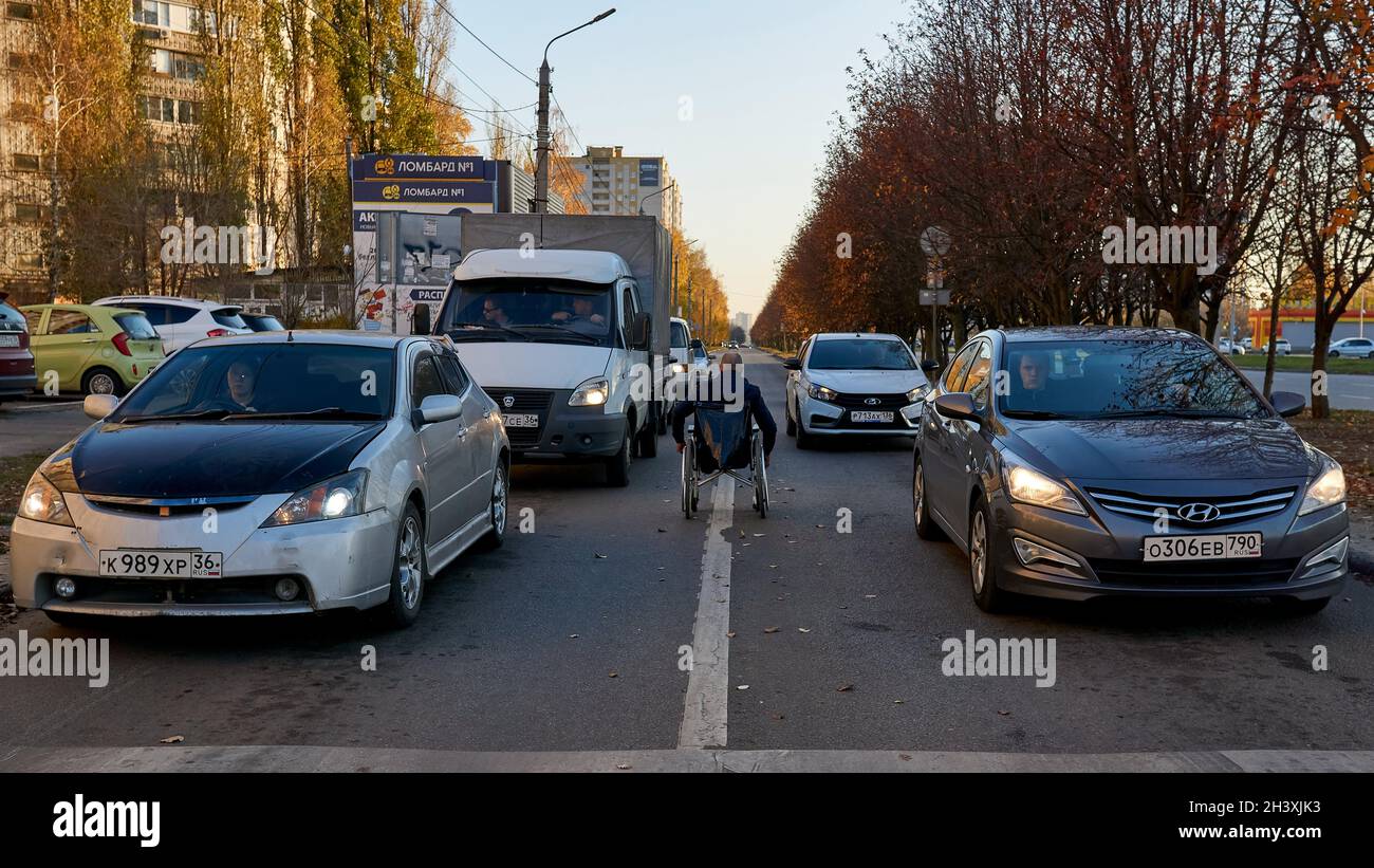 A man in a wheelchair begs for alms between cars, amid the lockdown ...