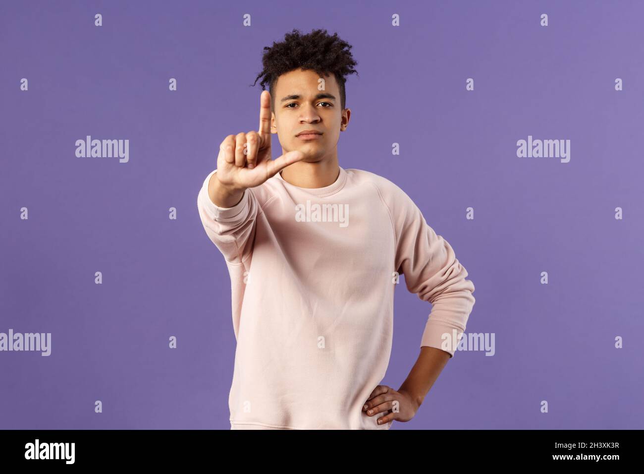 Not so fast, stop. Portrait of young serious-looking hispanic elder ...