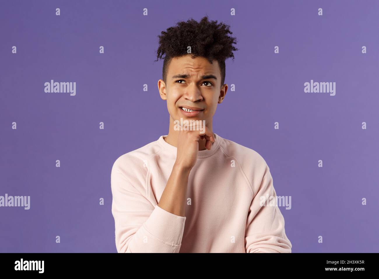 Close-up portrait of indecisive, puzzled young man facing difficult ...