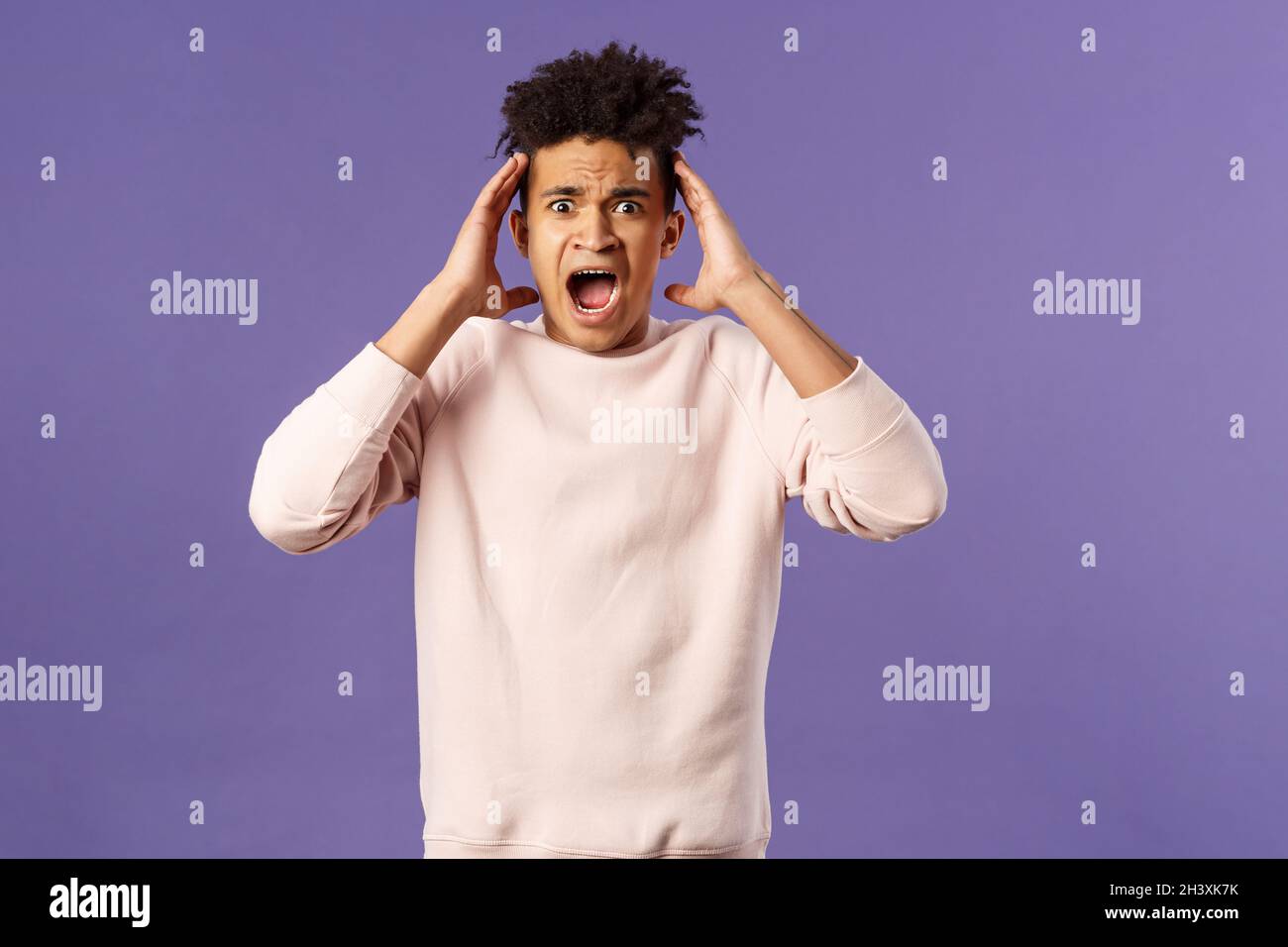Portrait of scared and anxious young hispanic handsome man in panic ...