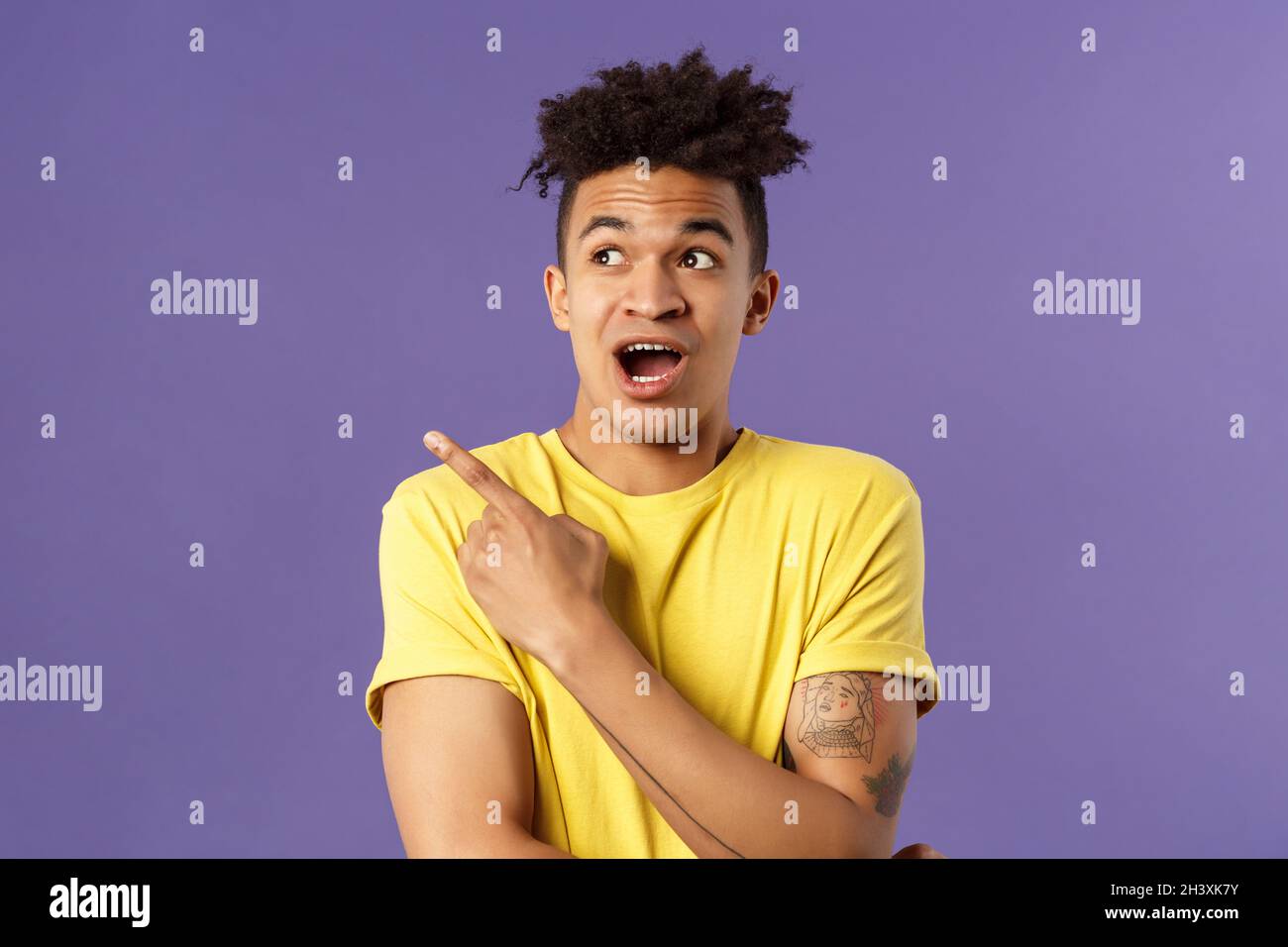 Portrait of impressed hispanic guy seeing something interesting ...