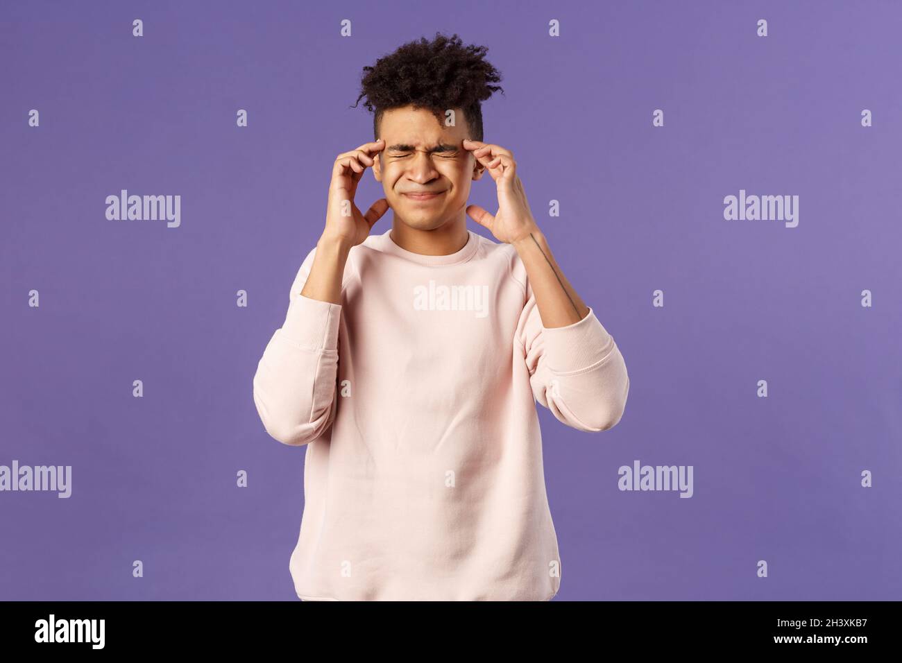 Portrait of intense, pressed young male student overworked, feel tired ...