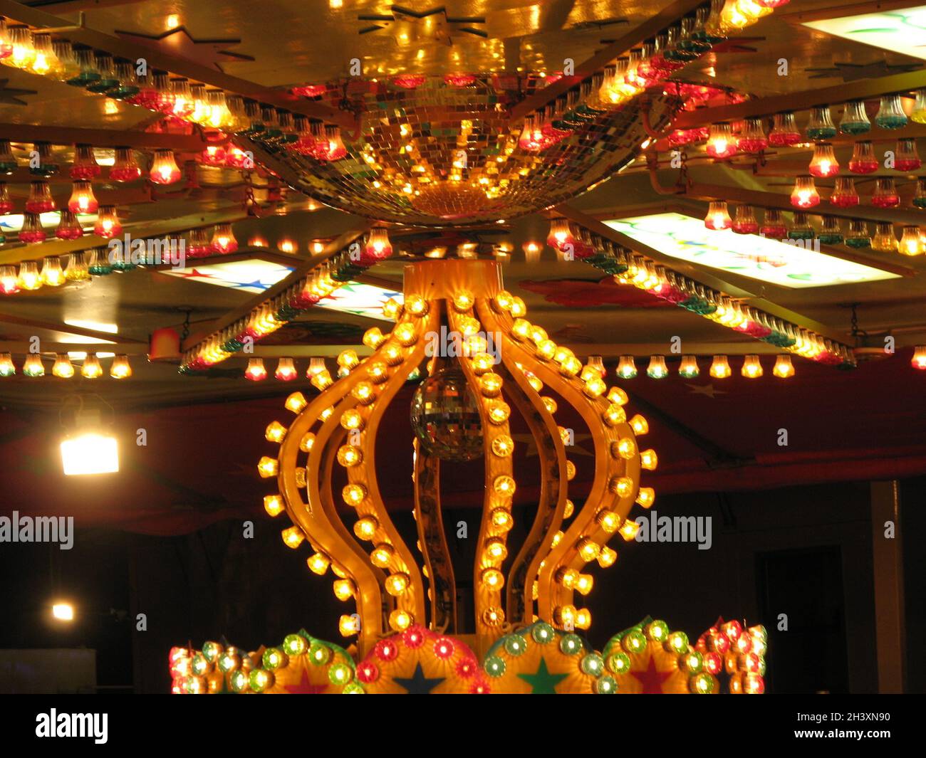 Colorful carousel lights in a dark room Stock Photo - Alamy