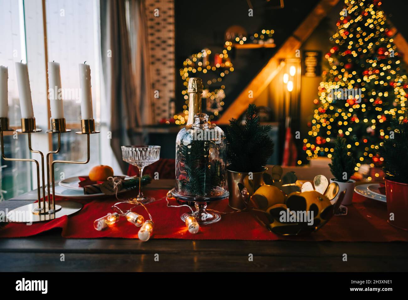 Festive Christmas table in the kitchen with a big Christmas tree and ...