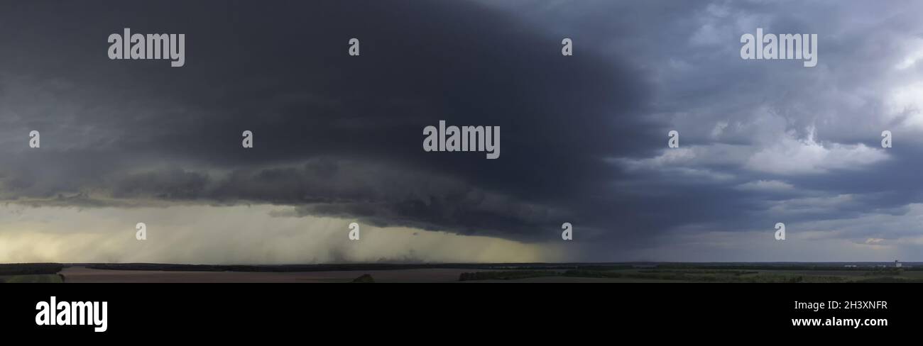 Dramatic panorama with dark storm clouds. A thunderstorm that raises ...