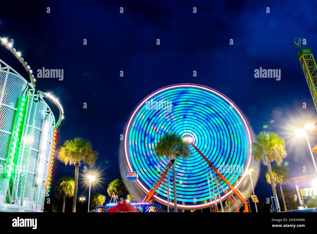long exposure of amusement rides at night with vibrant lights Stock ...