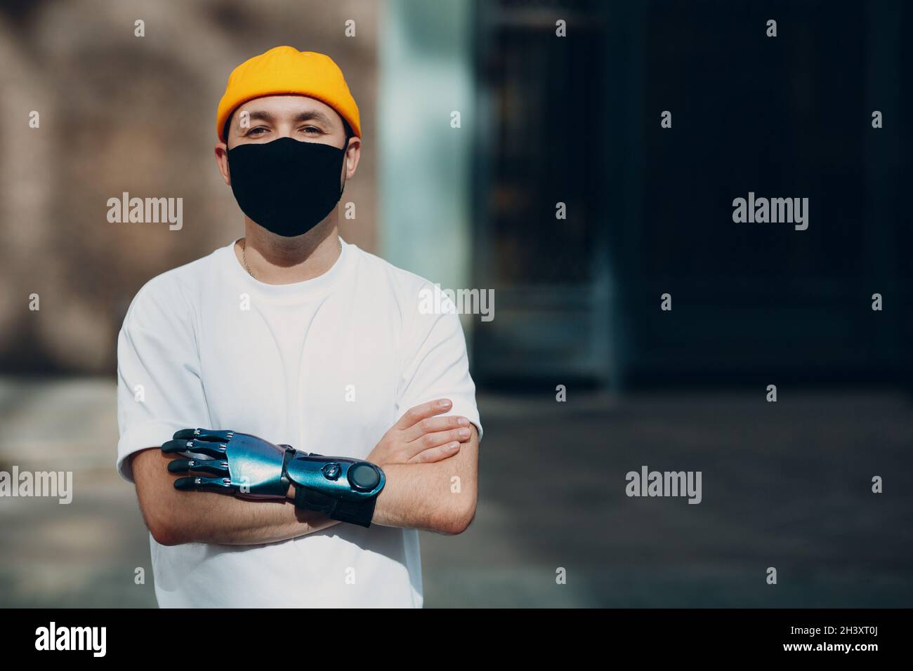 Young disabled man with artificial prosthetic hand wearing medical ...
