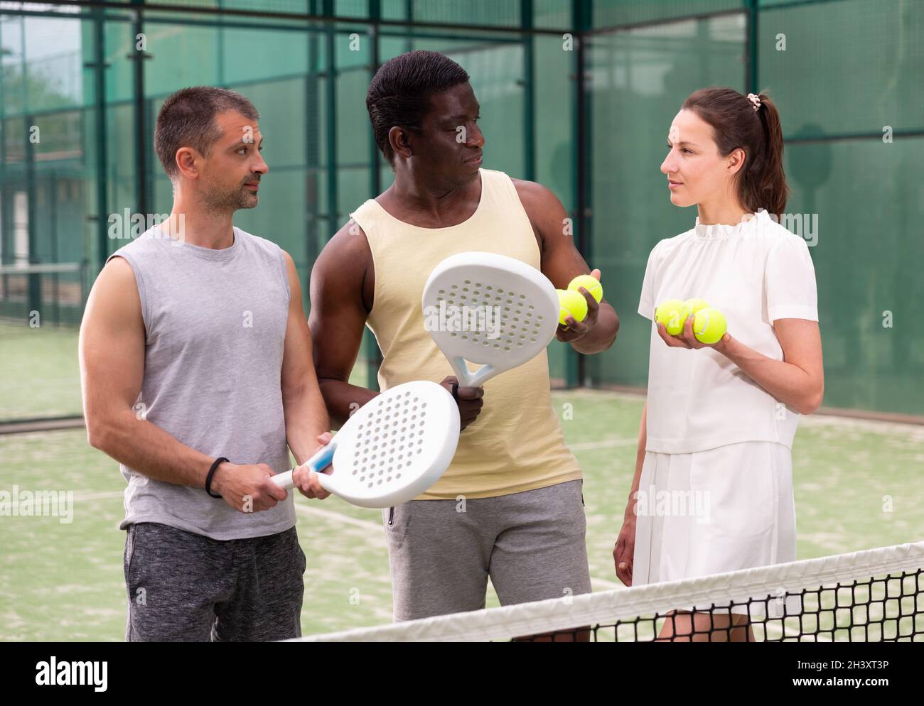 Portrait of three padel players on tennis court Stock Photo - Alamy