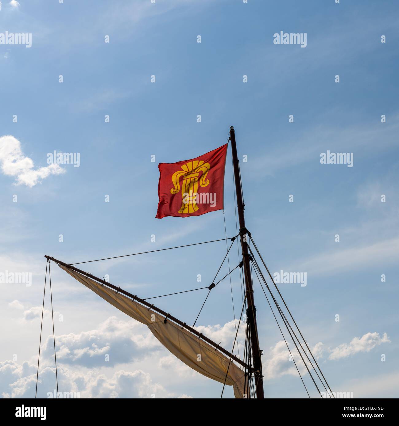 Flag of the Finnish city of Vaasa flying in a strong wind from the mast ...