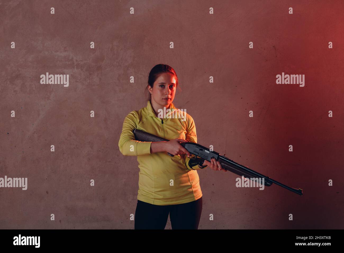 Young adult woman with rifle. Self defence concept Stock Photo - Alamy