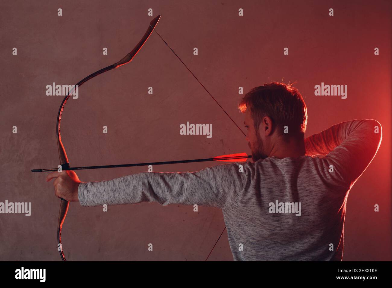 Archer bearded man with classic bow and arrow Stock Photo - Alamy