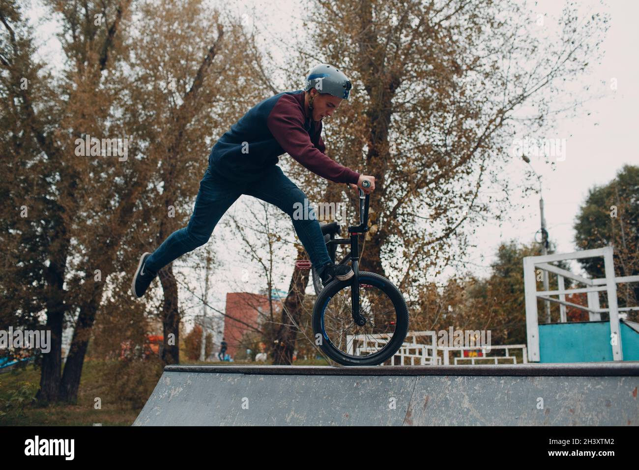Professional young sportsman cyclist with bmx bike at skatepark Stock ...