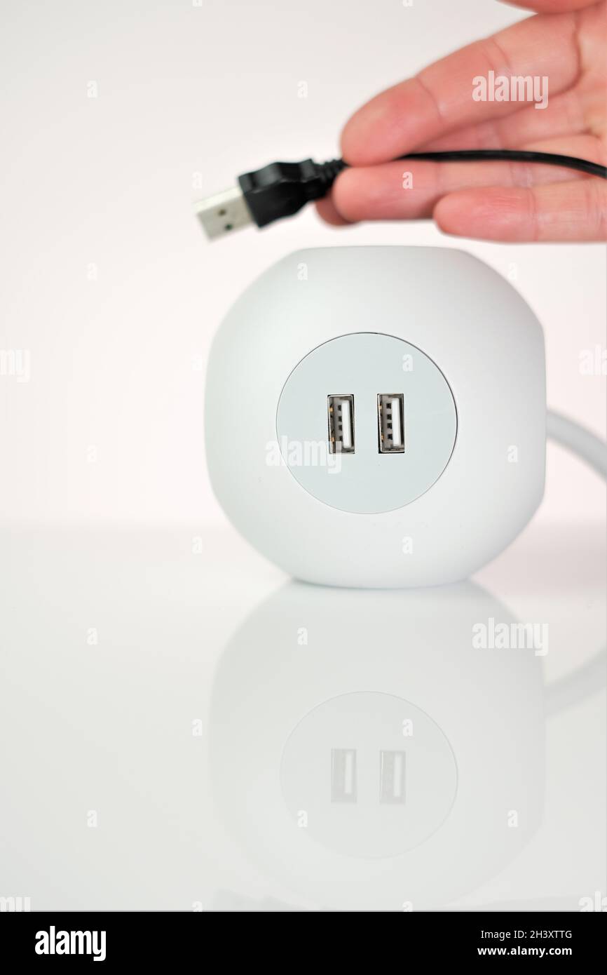 USB adapter.Socket with USB connector.Hands and USB cable in the ...