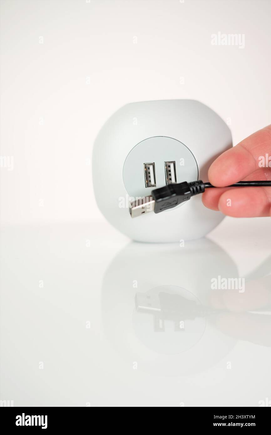 USB adapter.Socket with USB connector.Hands and USB cable in the ...