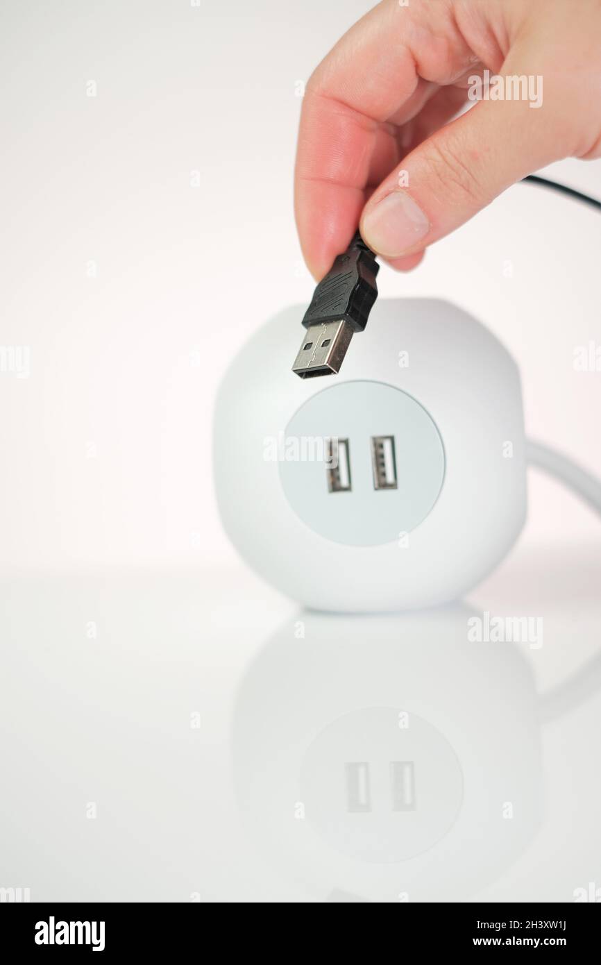 USB adapter.Socket with USB connector.Hands and USB cable in the ...