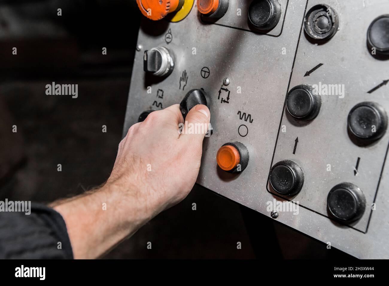 Human hand uses old control panel of industrial equipment in the ...