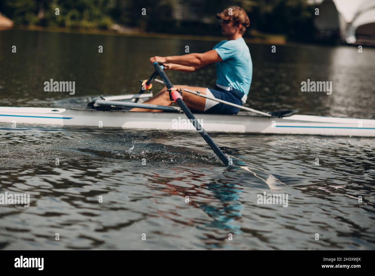 Sportsman single scull man rower rowing on boat Stock Photo - Alamy