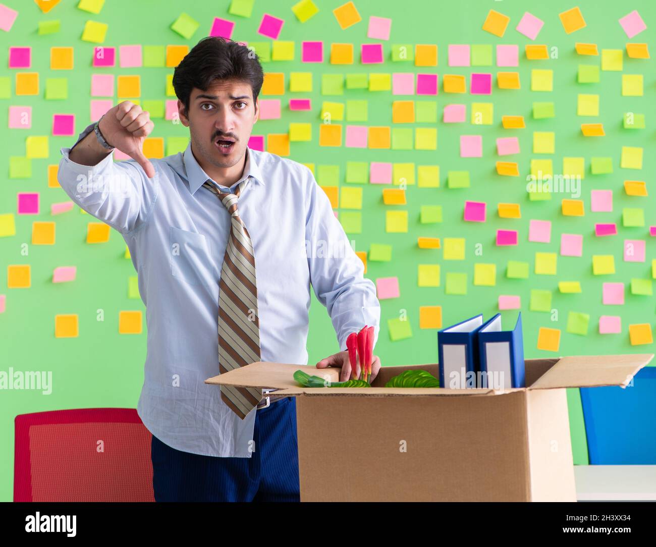 Man collecting his stuff after redundancy in the office with man Stock ...