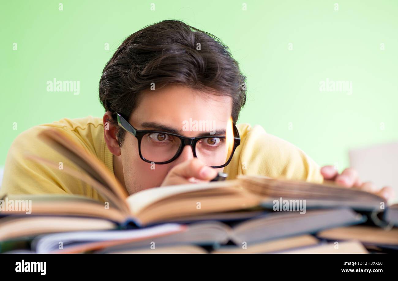 Student with too many books to read before exam Stock Photo - Alamy