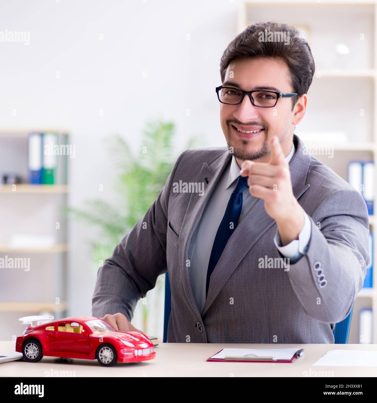 Agent offering car motor insurance Stock Photo - Alamy