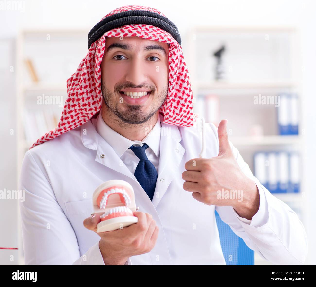 Arab dentist working on new teeth implant Stock Photo - Alamy