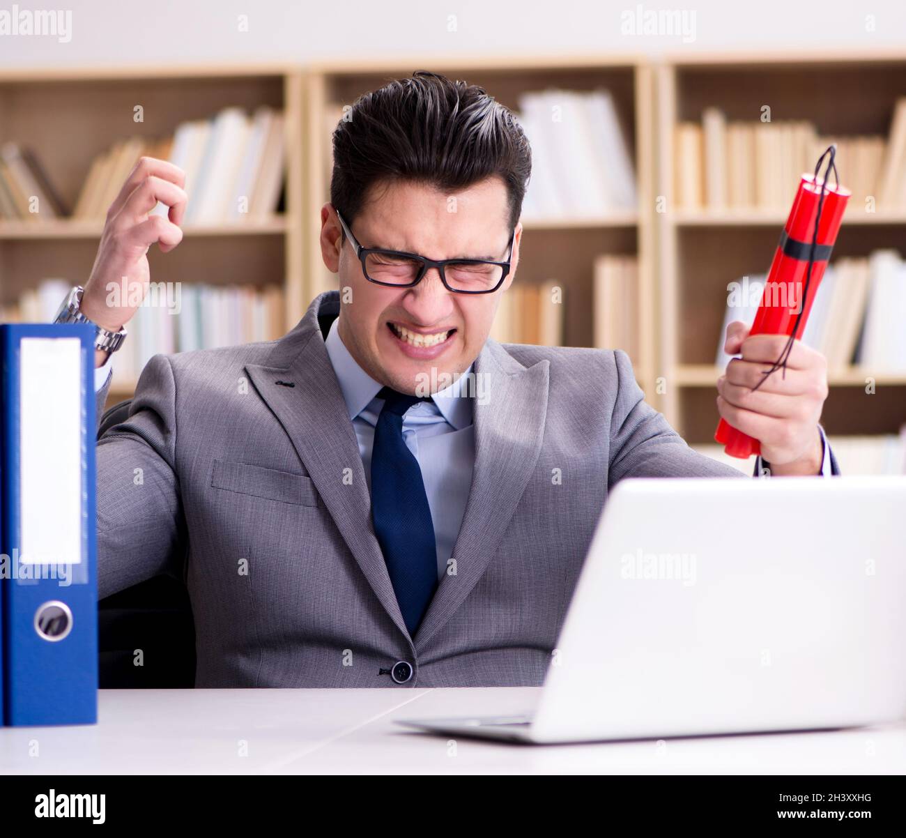 Businessman with dynamite in the office Stock Photo - Alamy