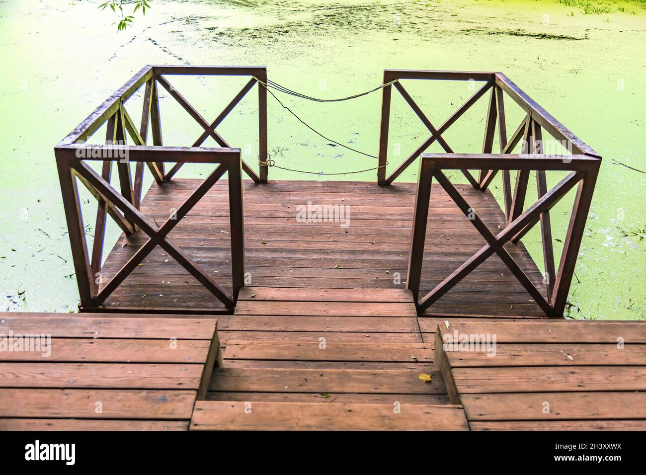 Empty wooden boat dock by an overgrown pond Stock Photo - Alamy