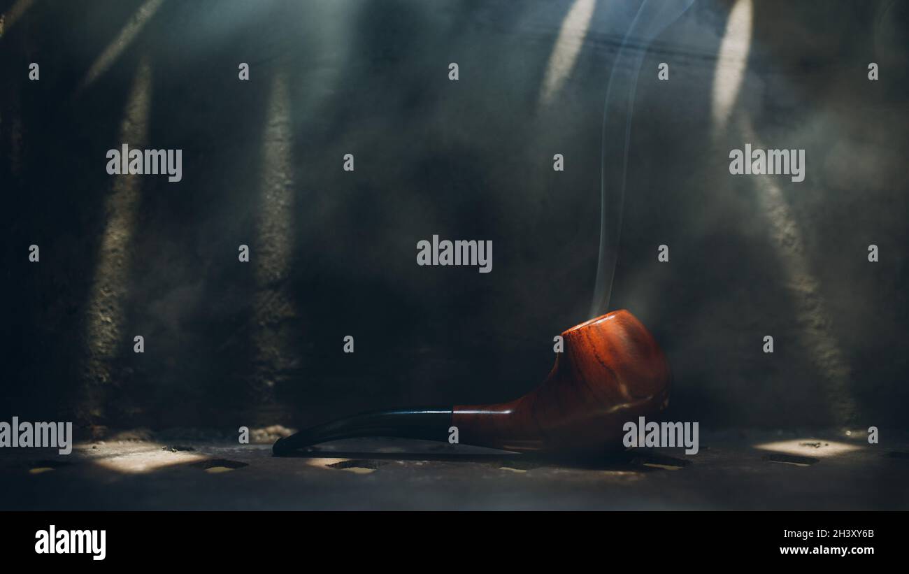 Smoking pipe on steel background with smoke Stock Photo - Alamy