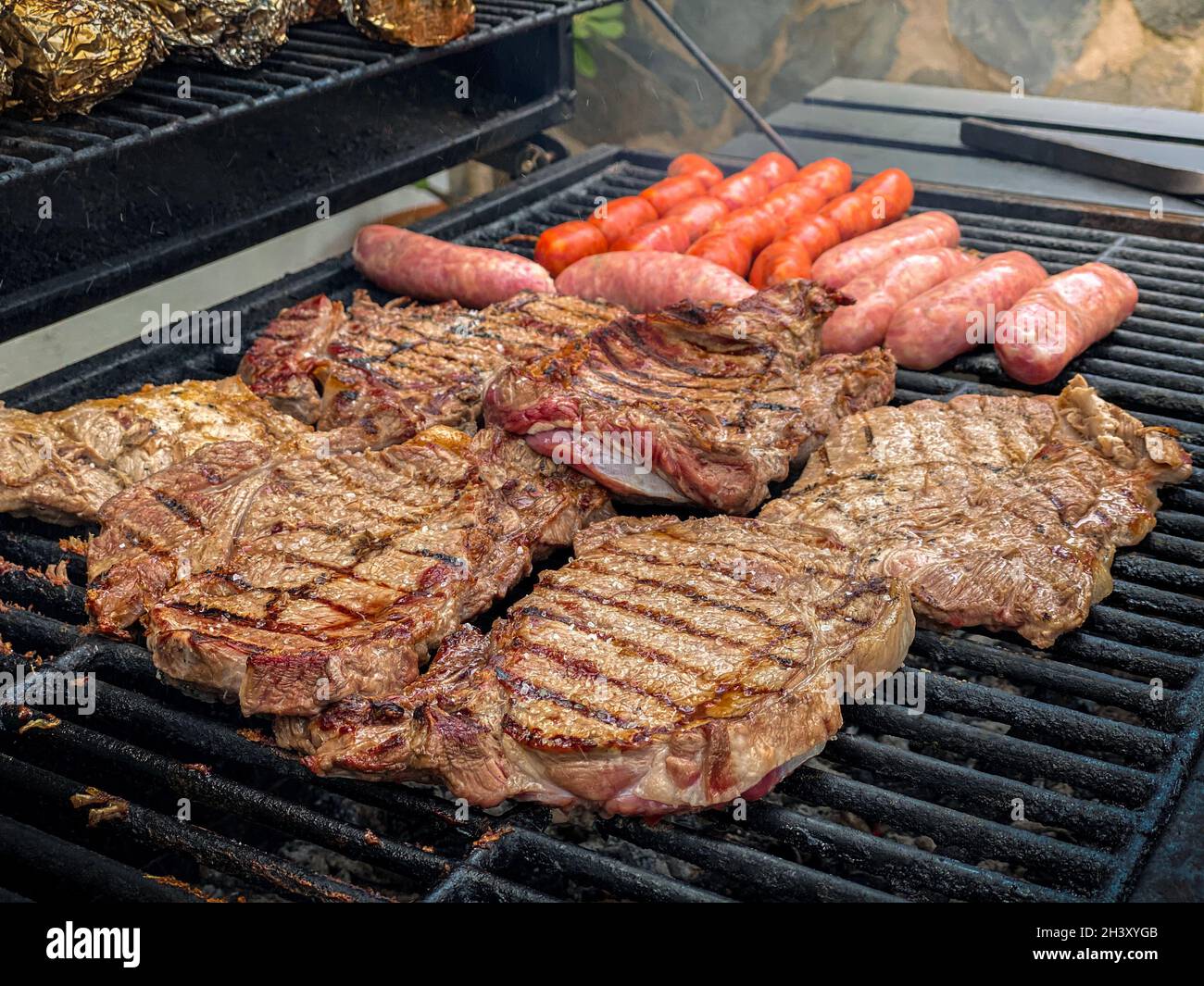 Cooking delicious steak beef and sausage of chorizo grill on hot coal ...