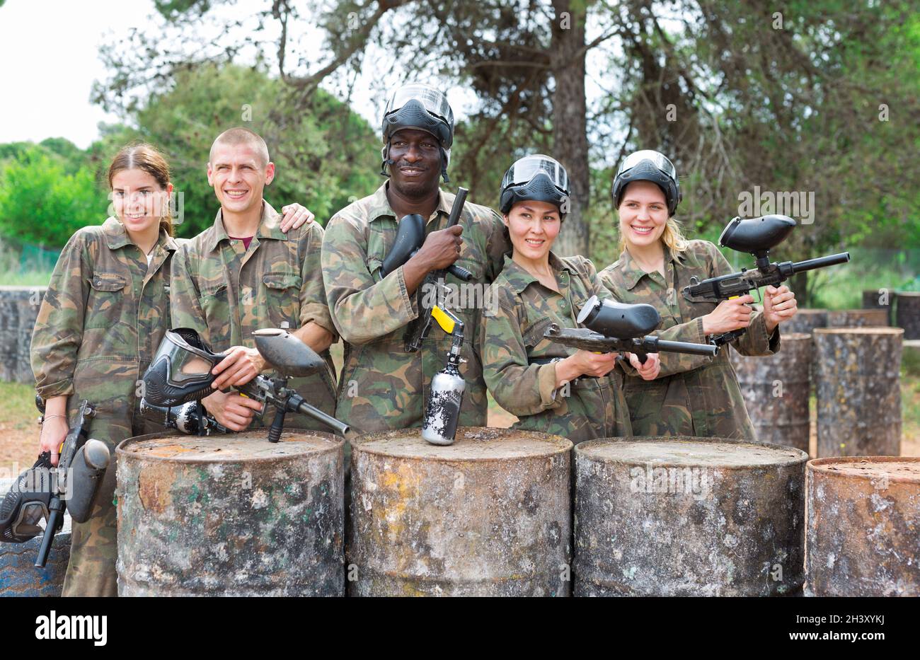 Group portrait of team of paintball players with marker guns Stock ...