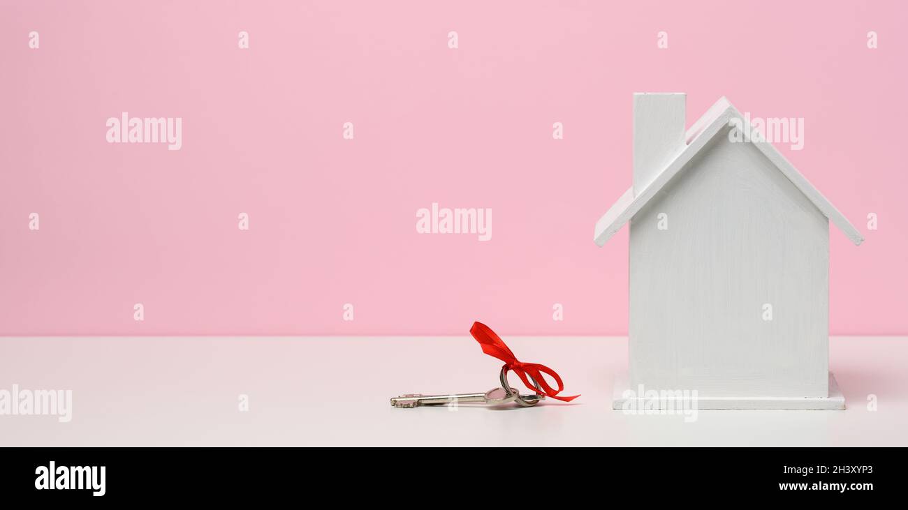 Wooden house on a pink background. Real estate rental, purchase and ...