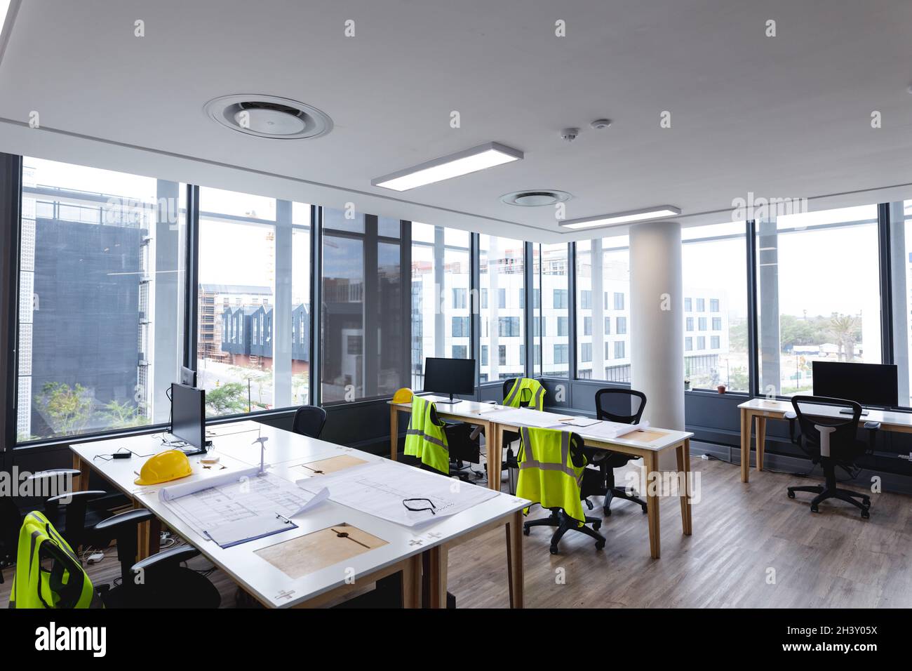 Interior of empty modern office with desks and computers Stock Photo ...