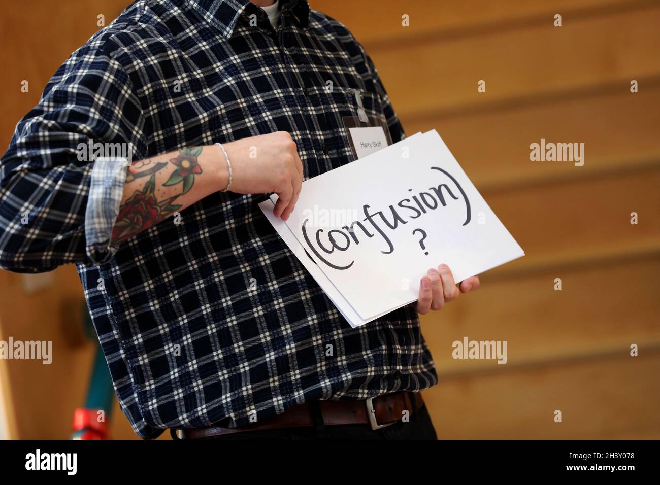 A man holding a sign for 'Confusion' during a speech Stock Photo - Alamy