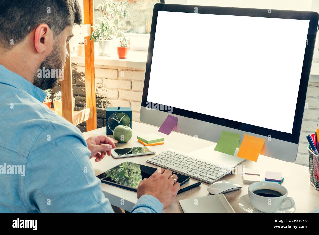 Office worker doing his job sitting at his working table with a ...