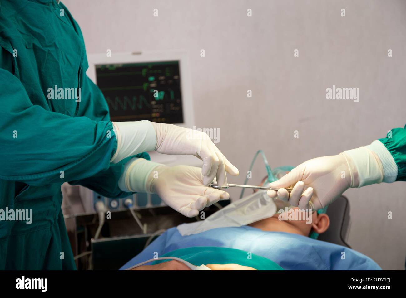 Closeup hands of doctor sending instrument with surgeon with rescue and ...